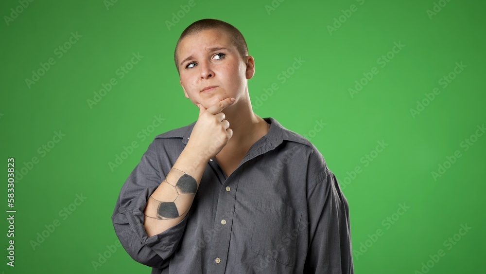 Foto de Portrait of thinking, smart puzzled pensive young non binary ...