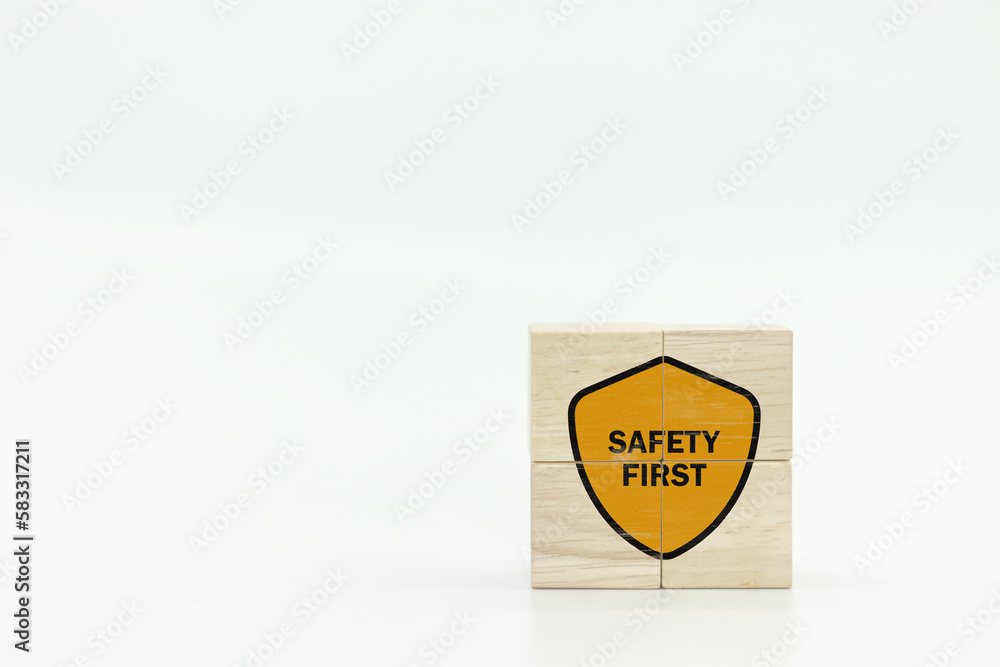 Shield icon and safety text on wooden cubes with white background ...