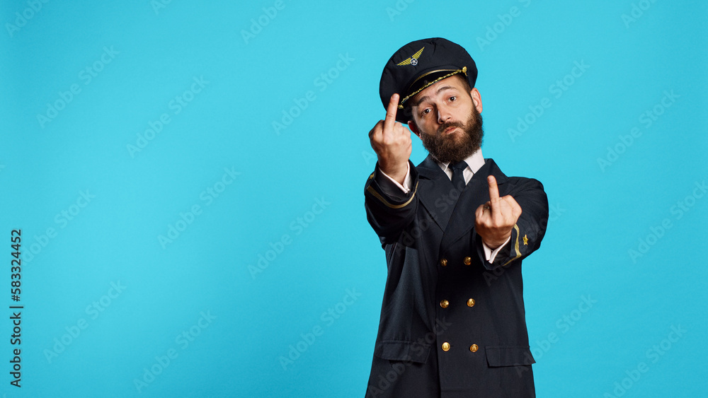 Caucasian airline captain showing middle fingers on camera, advertising ...