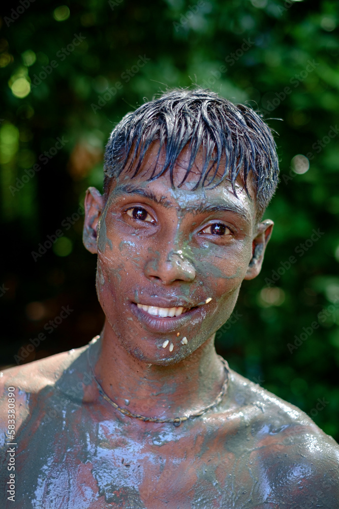 South asian hindu religious young aged handsome man playing with mud in ...
