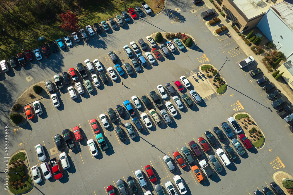 Aerial view of large parking lot with many parked colorful cars ...