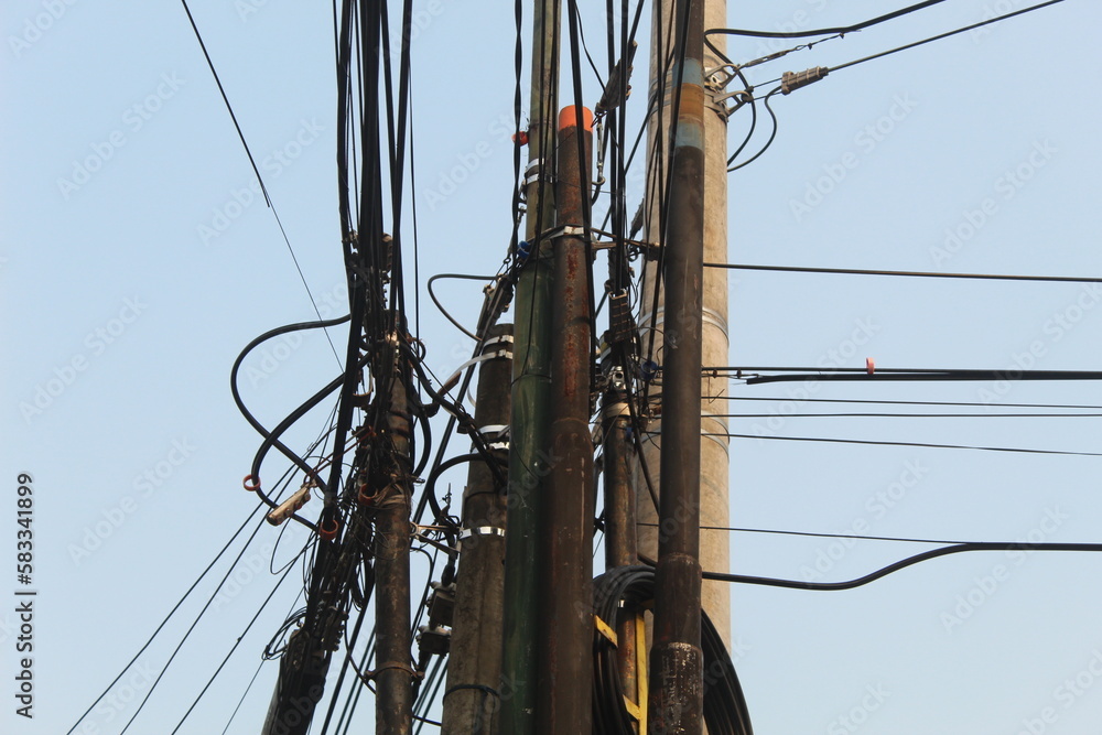 Electric poles and wires against a blue sky make for a striking image ...