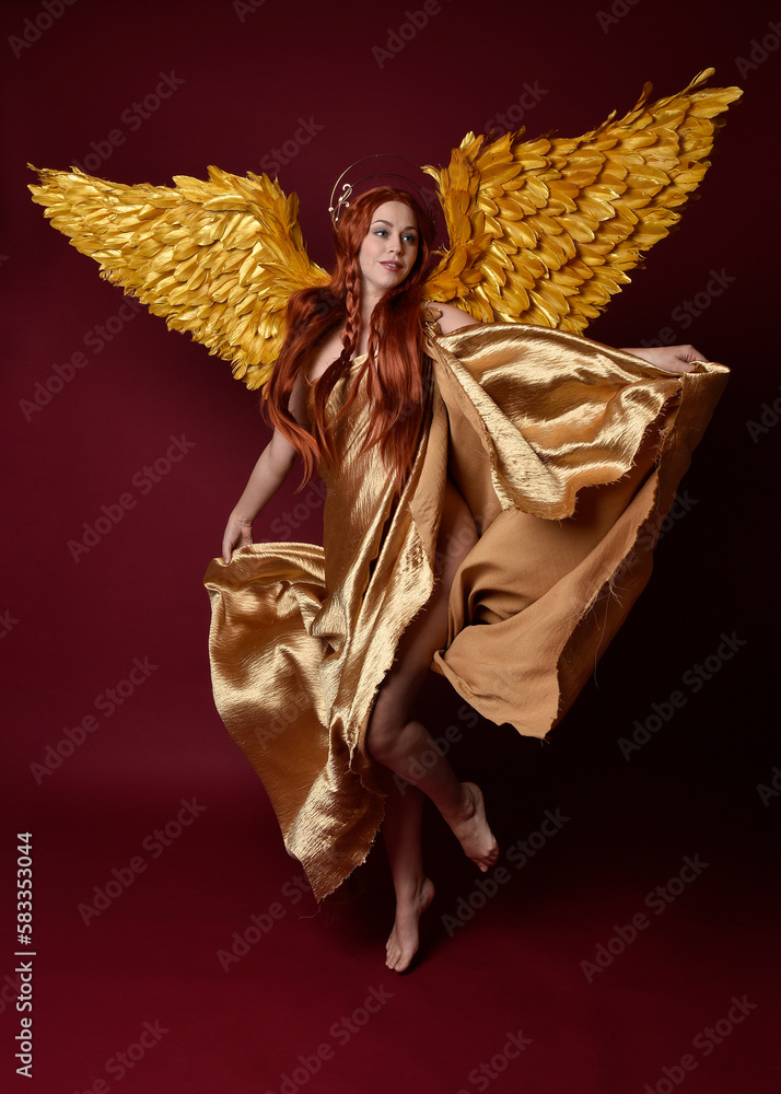 Full length portrait of beautiful woman model with long red hair, gold ...