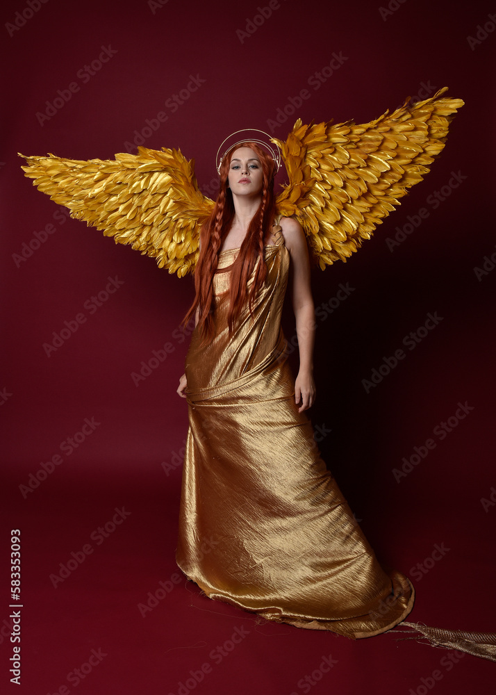 Full length portrait of beautiful woman model with long red hair, gold ...