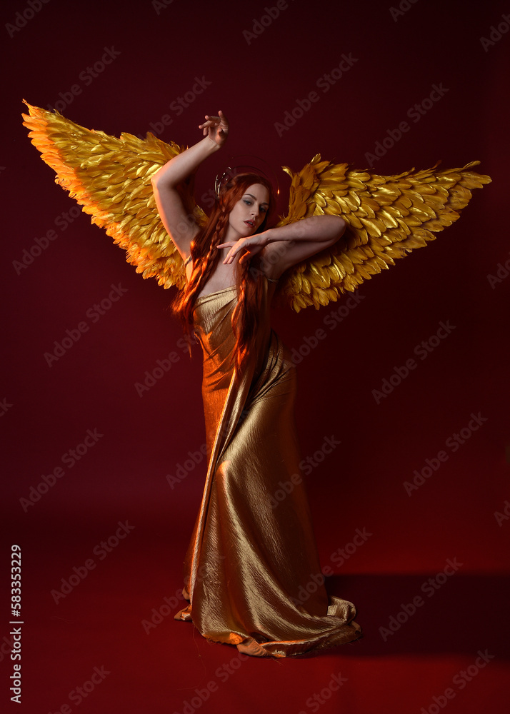 Full length portrait of beautiful woman model with long red hair, gold ...