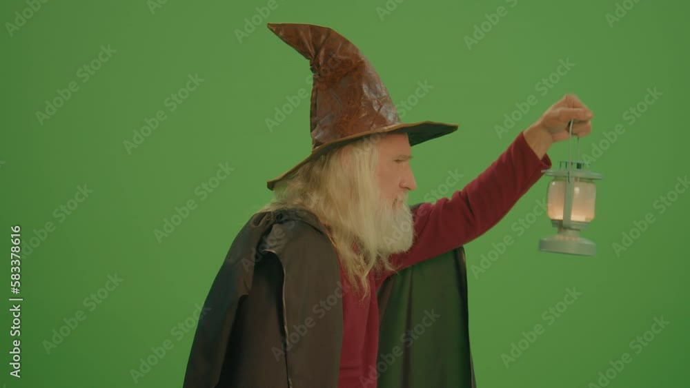 Green Screen. An Old Wizard in a Magic Hat and in Medieval Clothing ...