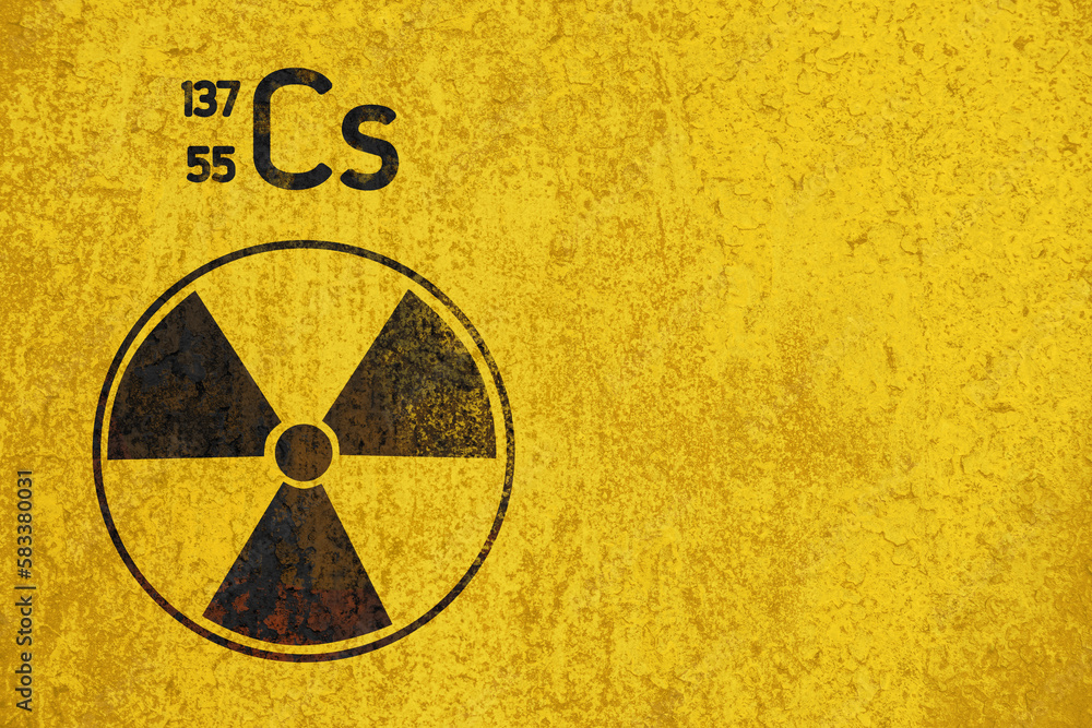 Nuclear energy radioactive round black symbol shape on yellow cement ...