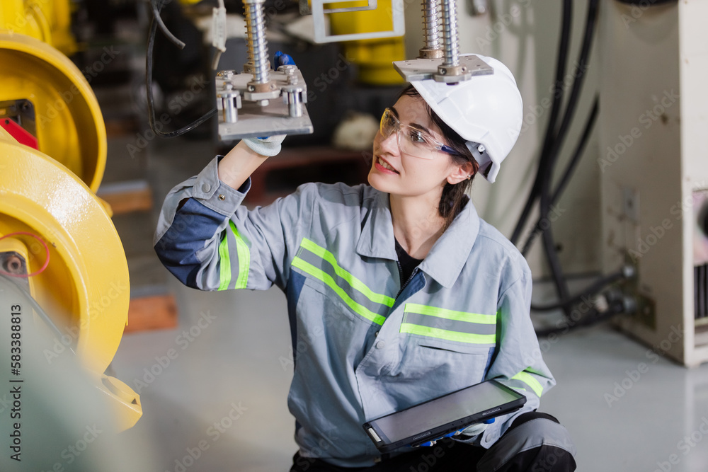 Engineers woman use tablet to check condition robotic arm. female ... Engineers woman use tablet to check condition robotic arm. female ...