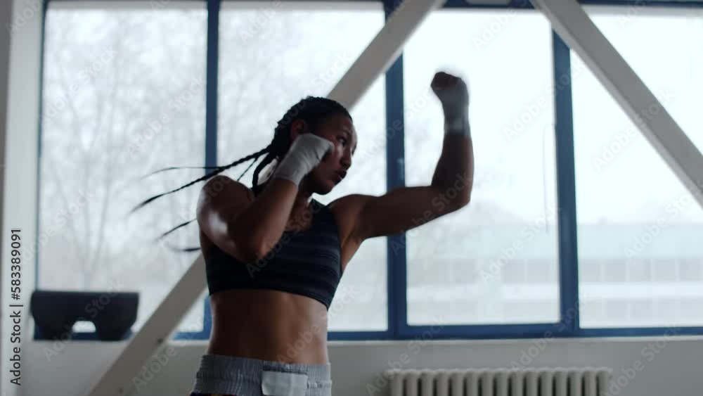 Young asian female boxer with wrapped hands bandage fighting with the ...