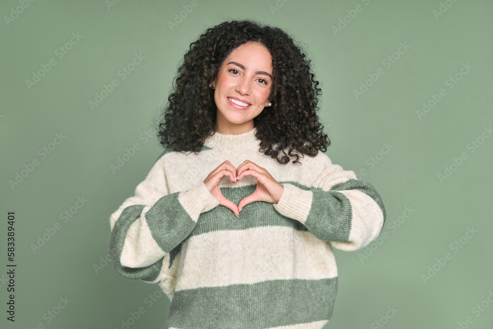 Young happy latin woman showing heart making shape with hands isolated ...