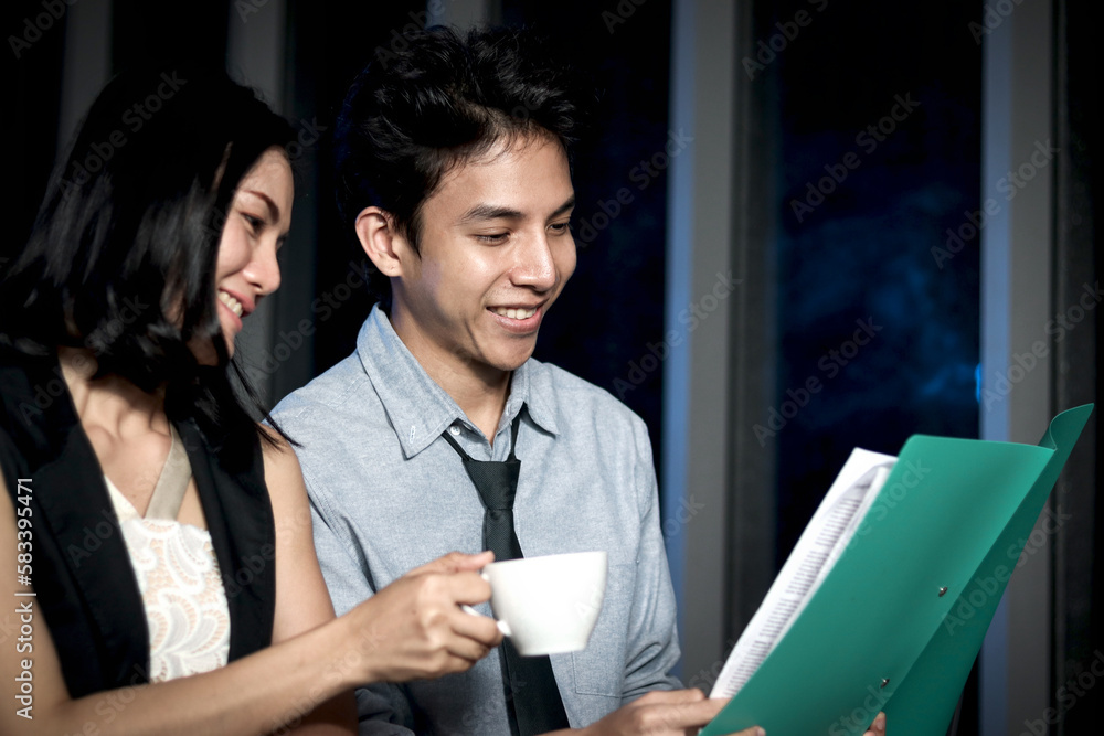 Happy smiling Asian business man and woman working together, looking ...