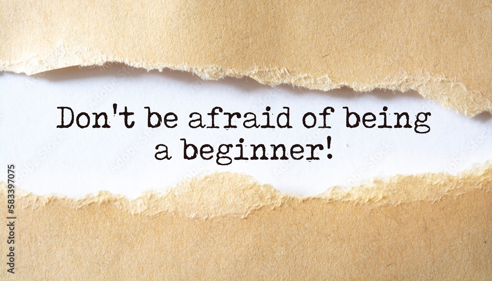 Don't be afraid of being a beginner. Words written under torn paper ...