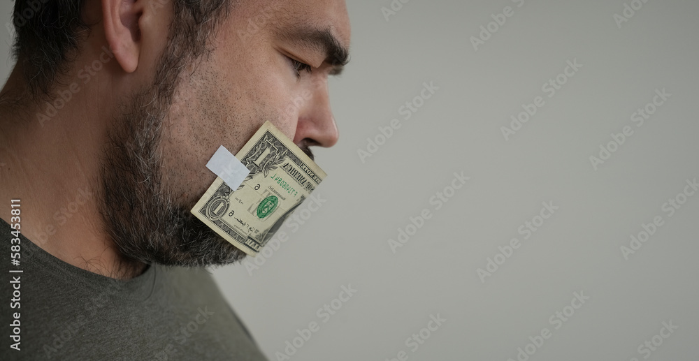 The man's mouth is sealed with dollars, money. The concept of buying ...