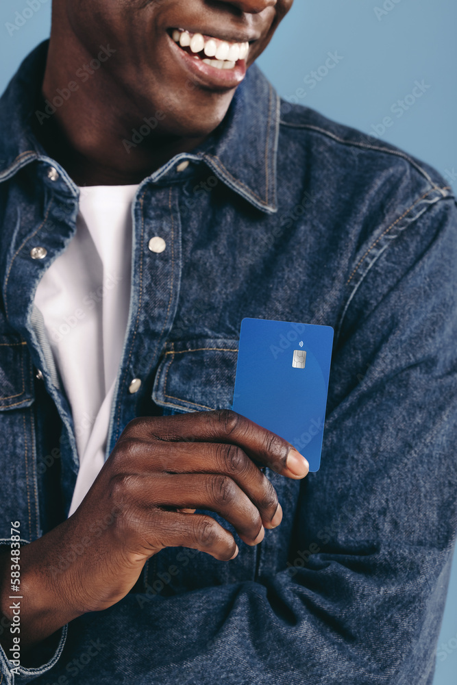 Paying with an easy tap. Young black man smiles while holding out his ...