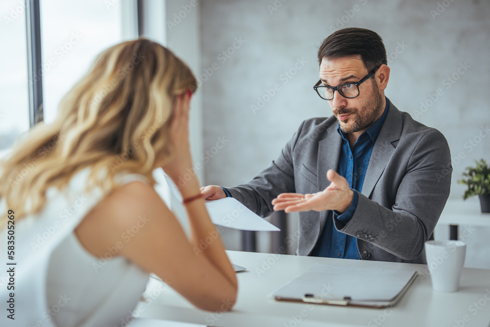 Angry businessman arguing with businesswoman about paperwork failure at ...