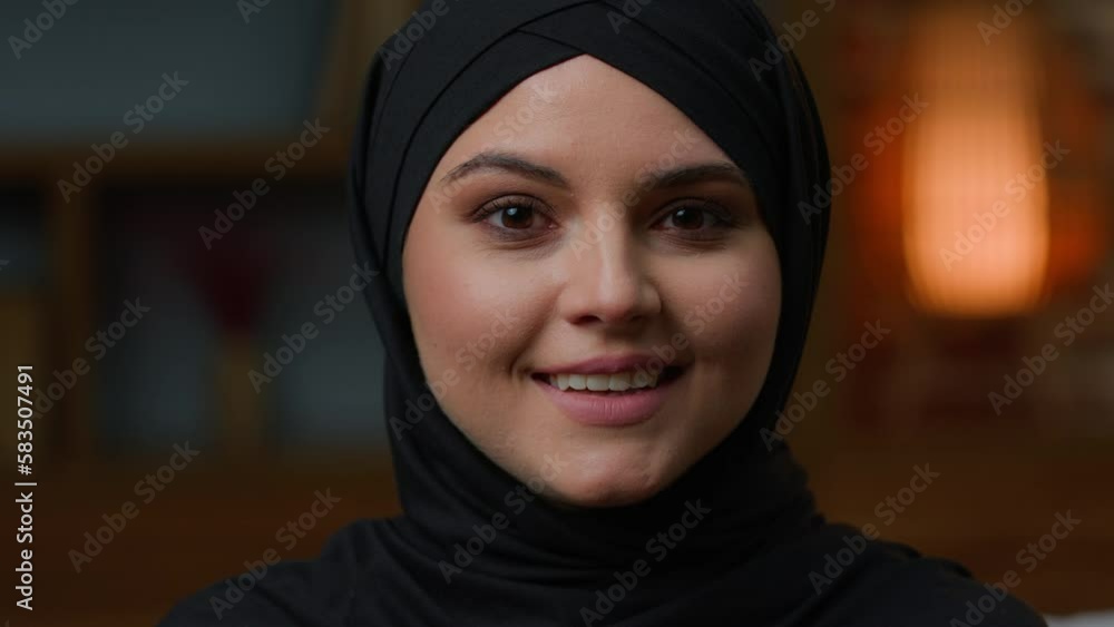 Portrait Arabian muslim woman in black traditional hijab looking at ...