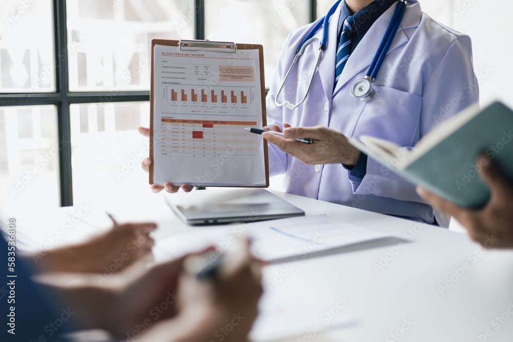 Team, medical analysts and doctors consulting with paperwork of graphs ...