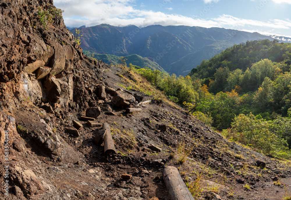 Rock slide damaged a hiking trail along the edge of a volcanic lava ...