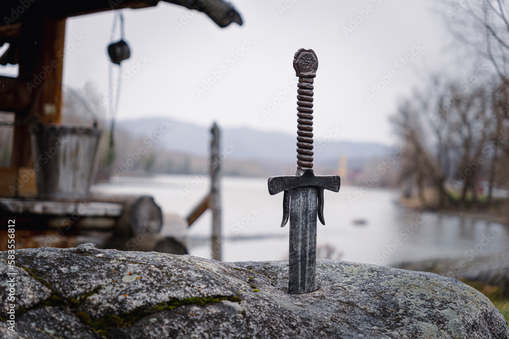 Excalibur, King Arthur's sword in stone. Edged weapons from the legend ...