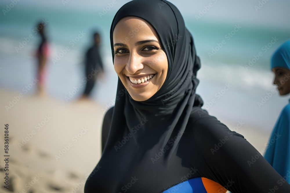 Portrait of young Muslim woman wearing burkini swimwear at the beach ...