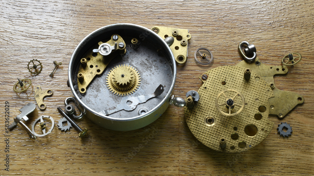 Still life with gear wheels and other elements of clock mechanism on ...