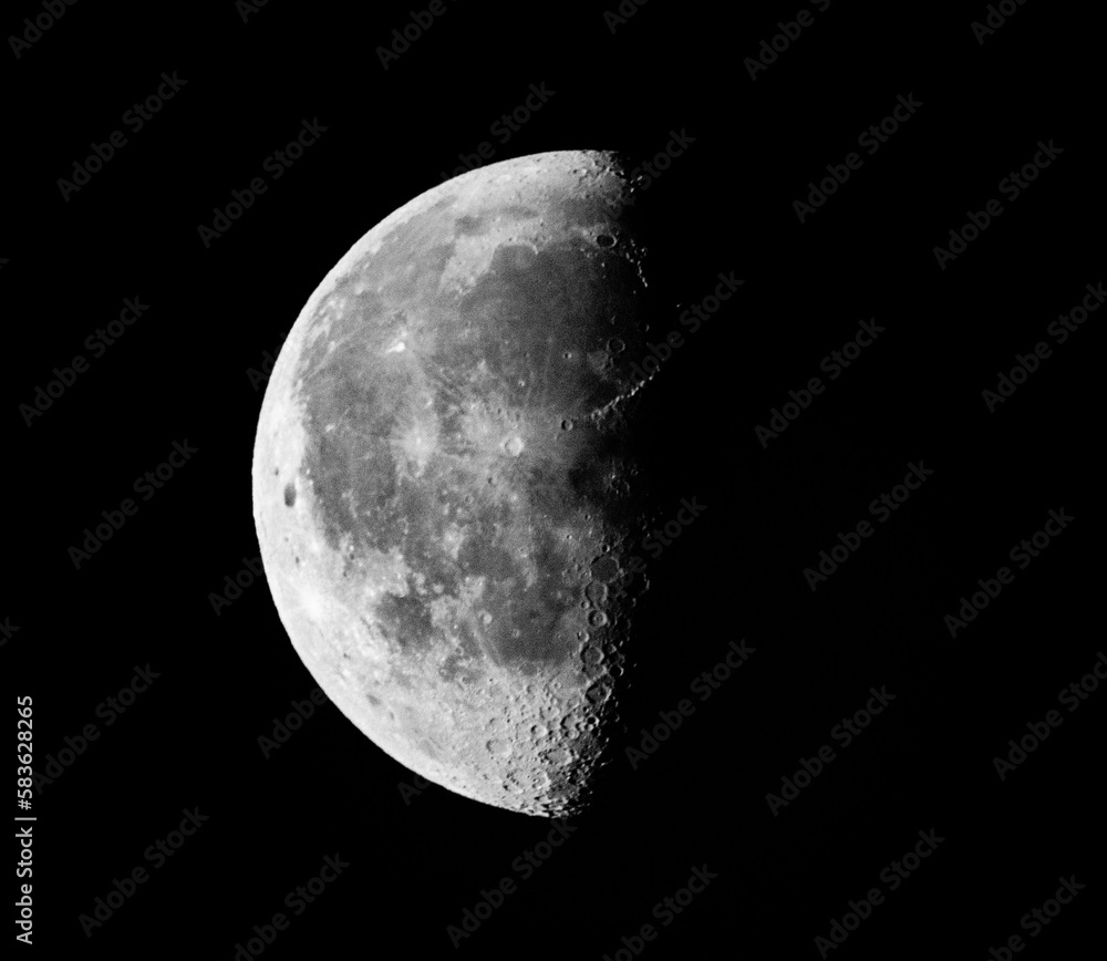 The waning gibbous moon glows softly in the night sky, its gentle ...
