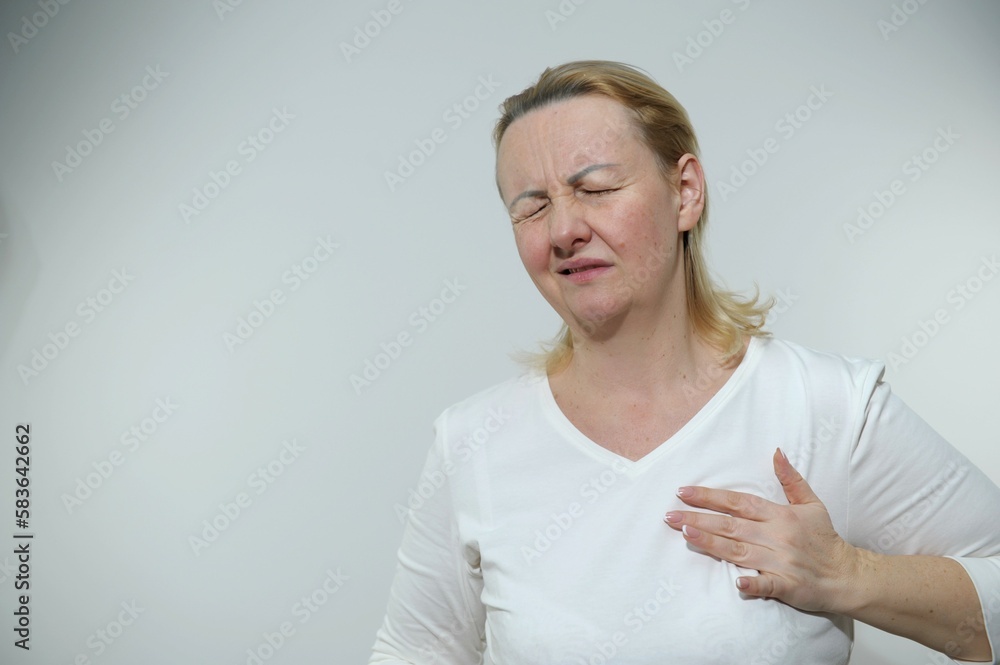 of adult woman heart hurts she put hand to chest she is tired she has ...