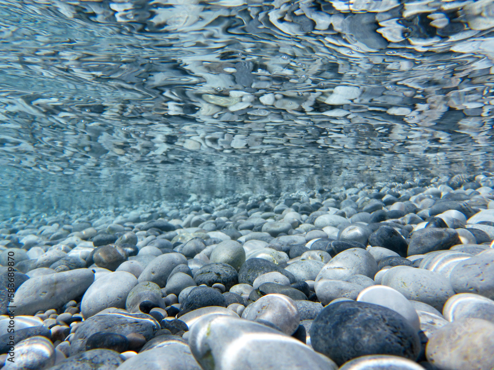 UNDERWATER sea level photo. Turquoise crystal clear water, pebbles of ...