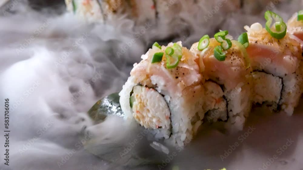 close-up black chopsticks take sushi with tuna california set next to ...