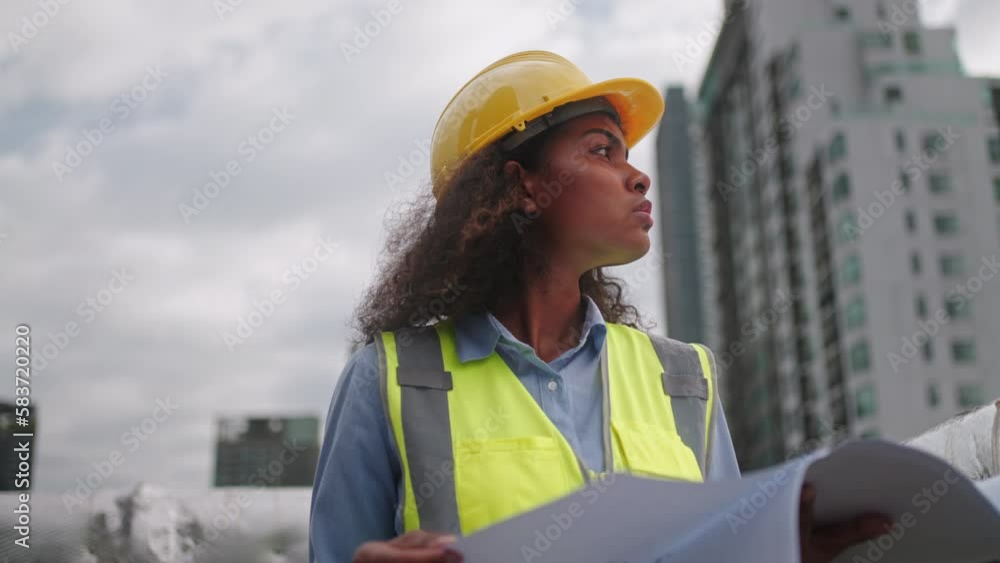 Civil engineer woman dark skin wearing uniform and safety helmet under ...