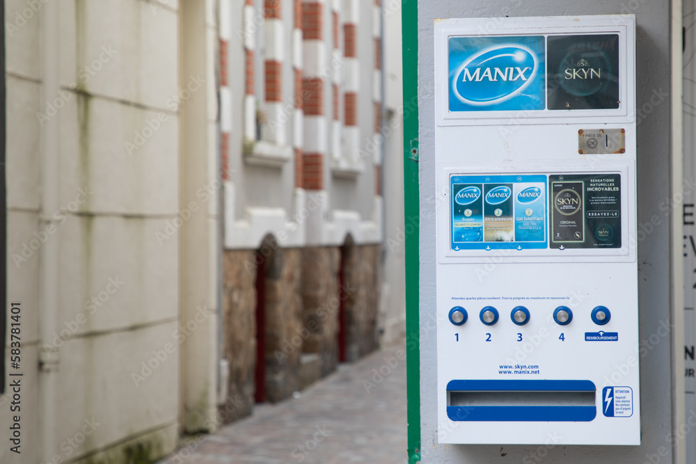 manix condoms automat vending machine on pharmacy street building wall ...