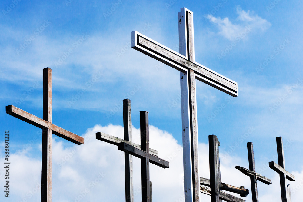 Big metal christian cross high in the blue sky. Symbol of love for ...