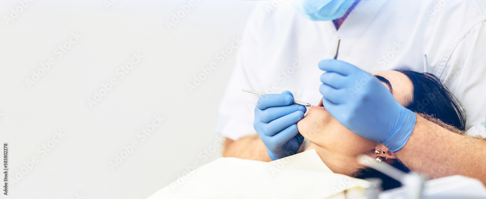 Dentist with patient in dental chair providing manipulations in oral ...