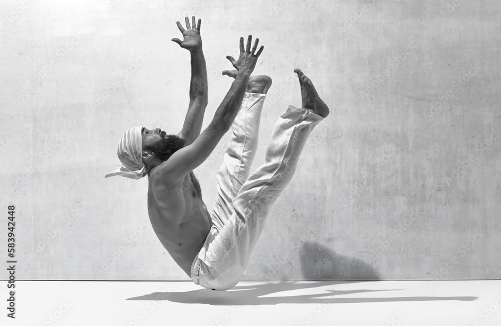 Black and white image, monochrome. Muscular bearded man training ...