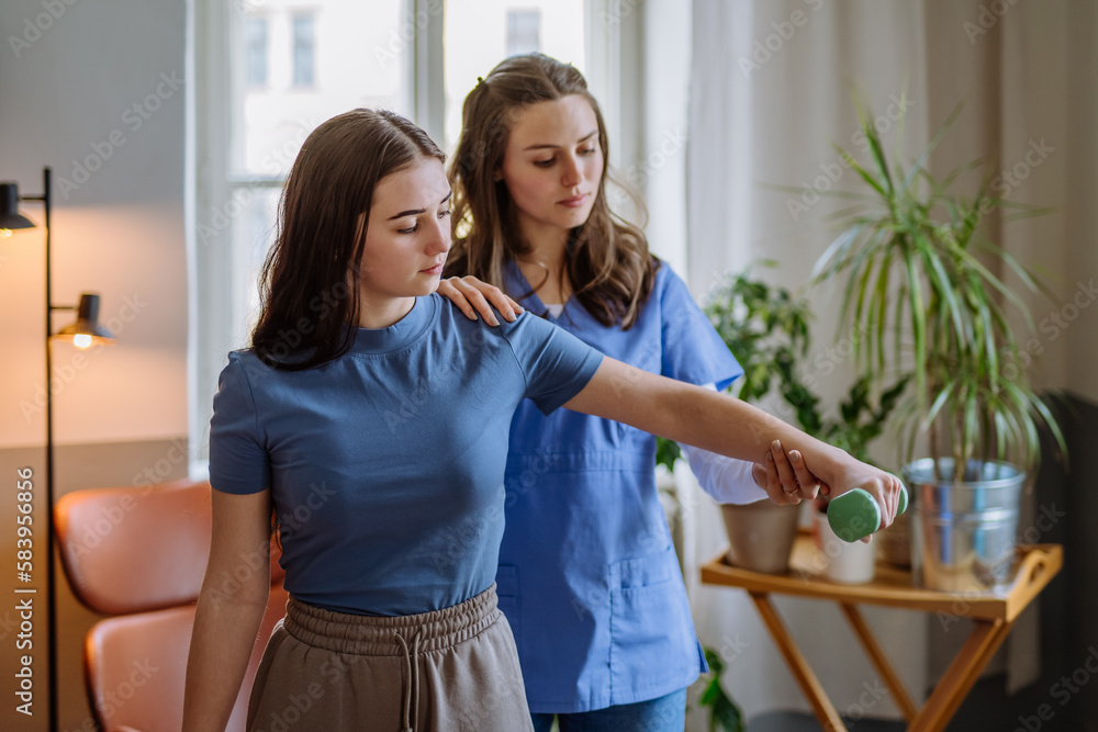 Teenage girl doing exercise with a nurse. Stock Photo | Adobe Stock