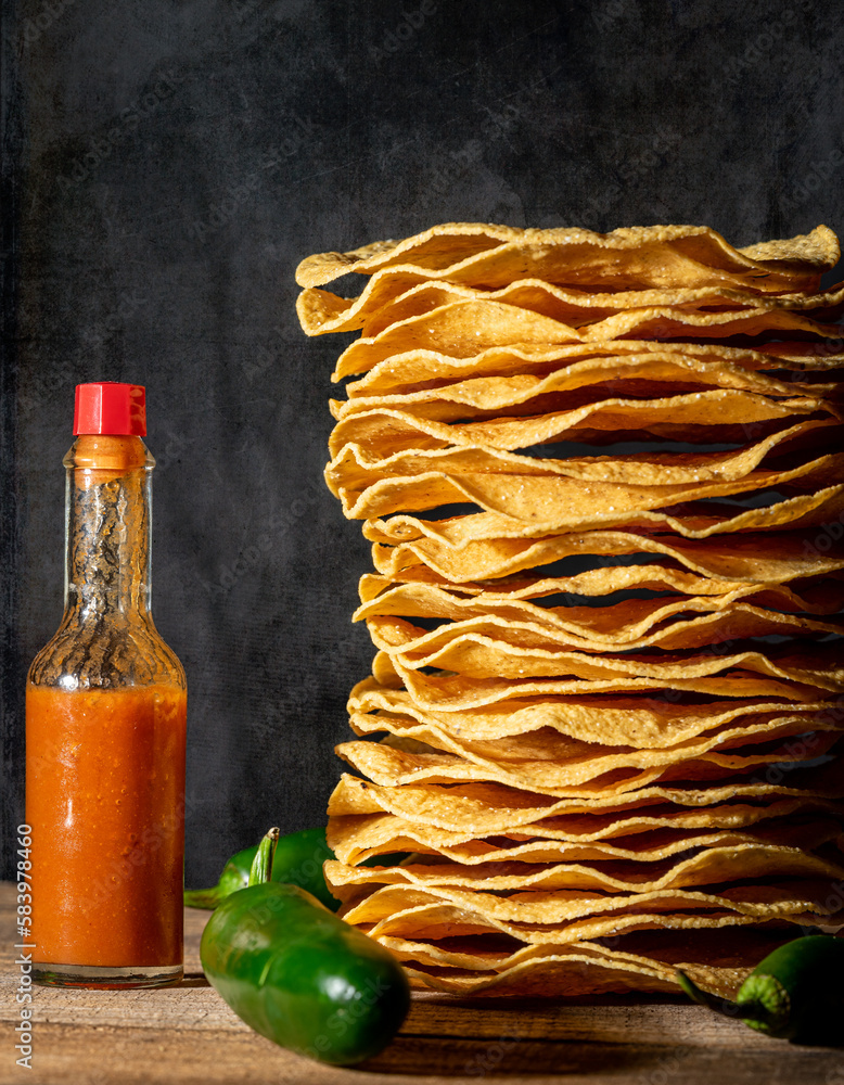 Yellow corn tostadas stacked with jalapenos and hot chili sauce ...