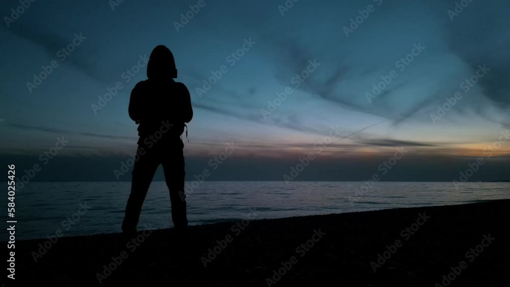 the silhouette of a guy at a beautiful sunset against the background of ...