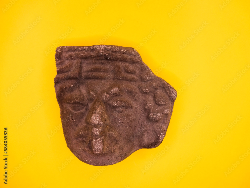 Mexican Mayan Aztec wood and ceramic mask on yellow background travel ...