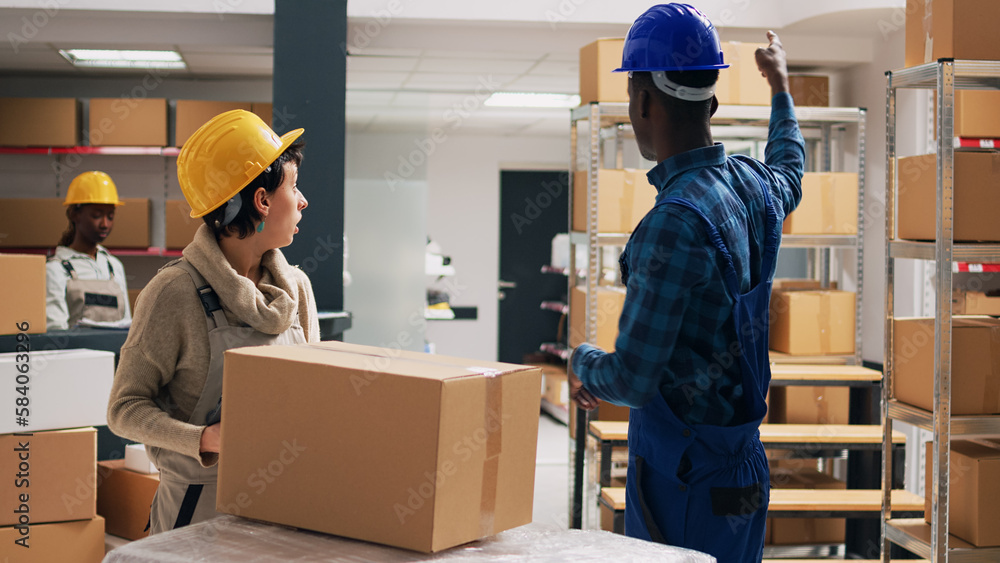 Male worker giving package of goods to supervisor, helping to scan ...