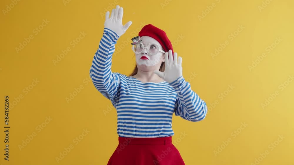 Female mime with perplexity emotion performs performance in an ...