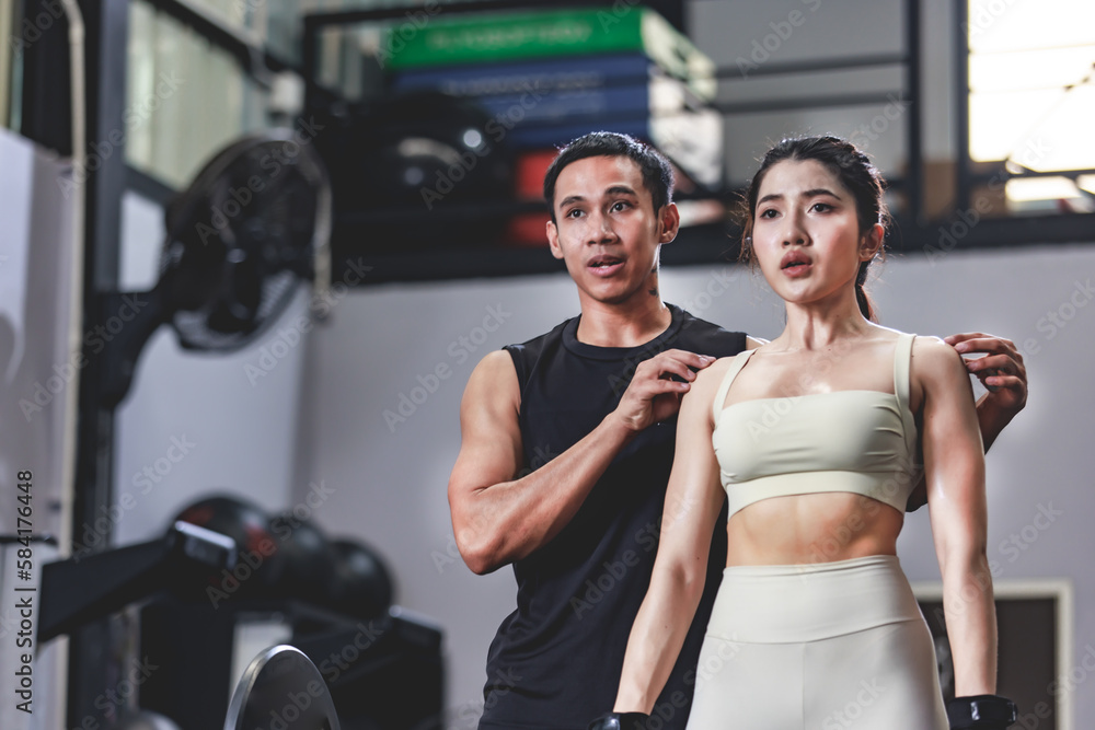 Asian professional male personal trainer coach adjusting posture of ...