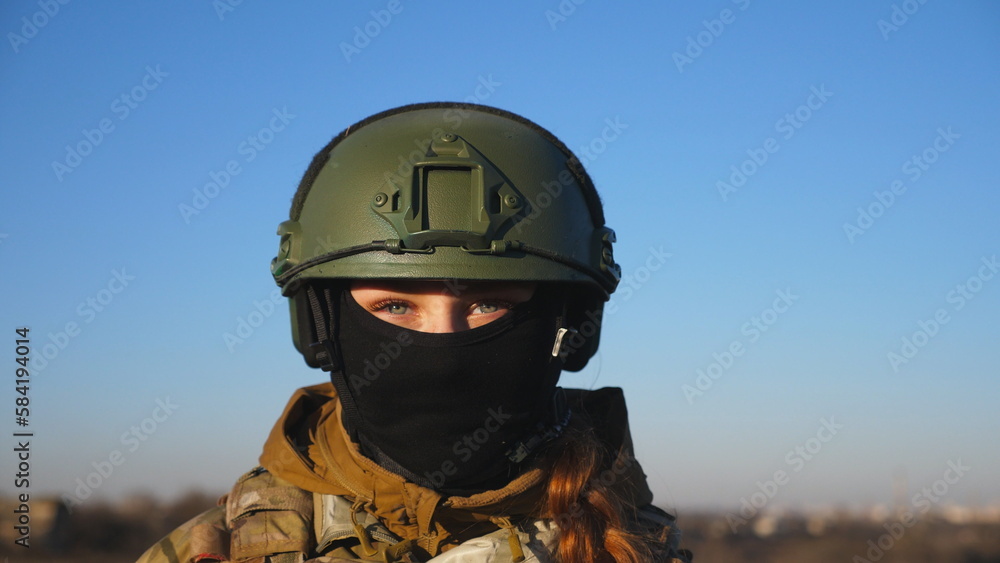 Happy military woman in helmet and balaclava fooling around around on ...