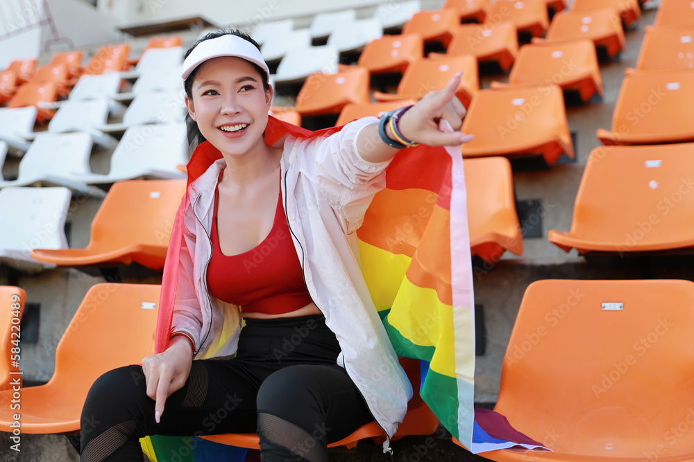 Happy and excited young female asian transgender LGBT sport fan ...