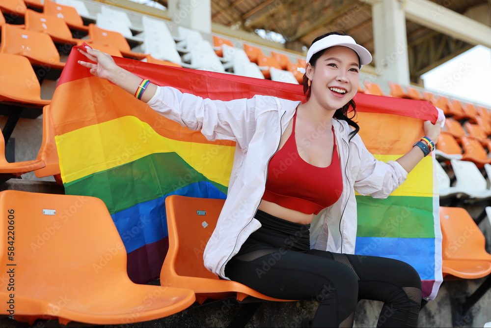 Happy and excited young female asian transgender LGBT sport fan ...