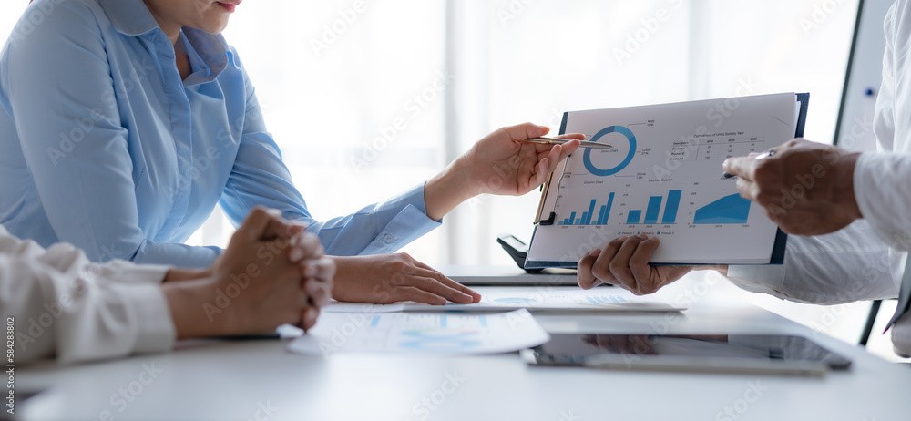 Business team together making investment plan at meeting pointing at ...