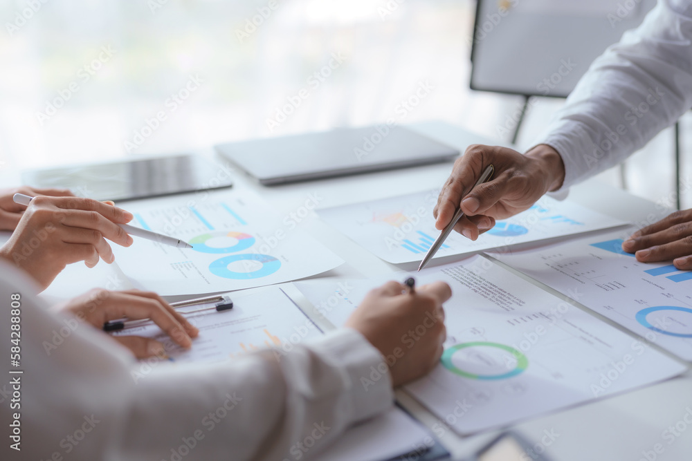 Business team together making investment plan at meeting pointing at ...