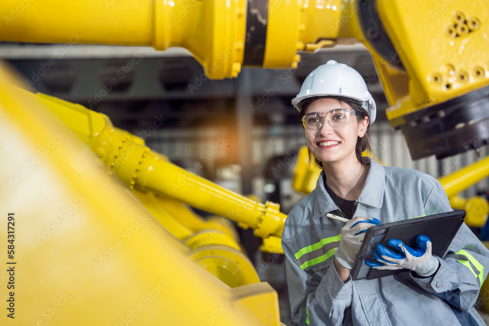 Fotka „Female engineer wearing safety uniform and helmet walks ...
