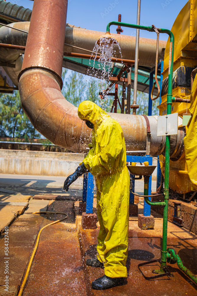Male workers dressing in protective shower detoxification suit clean up ...