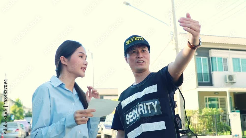 Asian woman handing over piece of paper asking for help from male ...