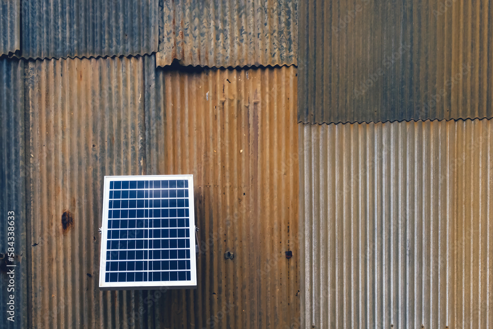 Solar panel attached on old zinc wall. Electric solar panel on the ...
